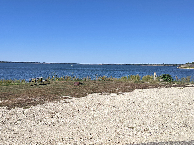 Tranquility has an address, and it's right here where water meets sky. A lone angler finds solitude while someone savors the view from shore.