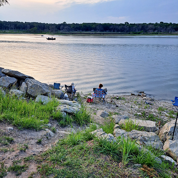 Tranquility has an address, and it's right here where water meets sky. A lone angler finds solitude while someone savors the view from shore.