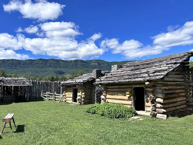 Log cabins at Martin's Station stand as silent witnesses to frontier life, with mountains providing a backdrop that hasn't changed in centuries.