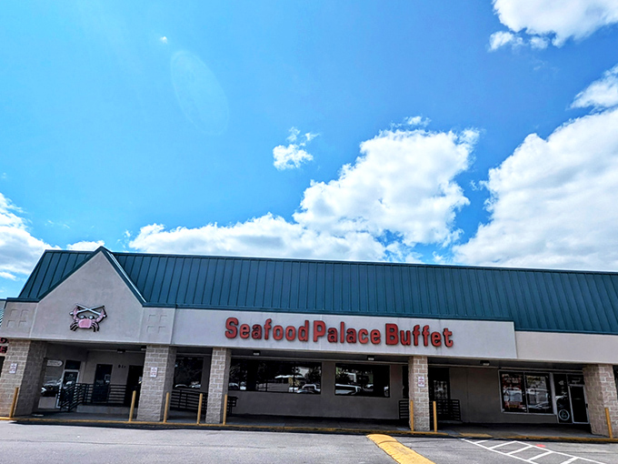 The unassuming exterior of Seafood Palace Buffet stands like a seafood speakeasy, its little crab logo promising treasures that belie its strip mall location.