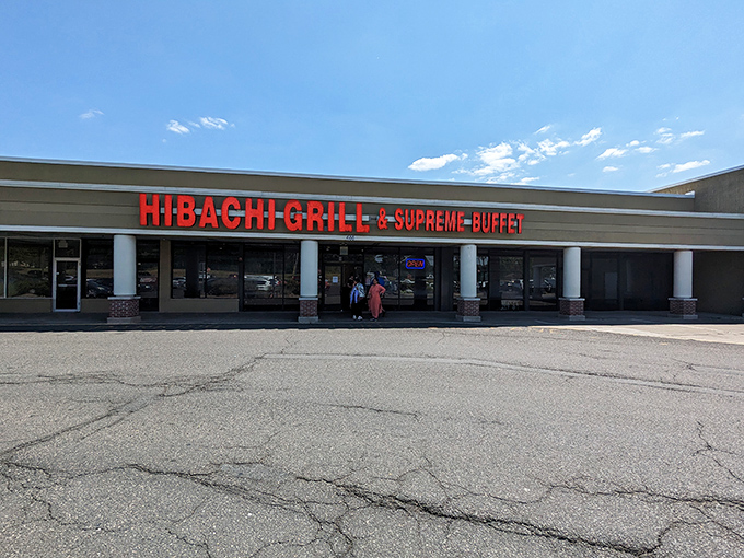 The bright red signage acts like a beacon for hungry souls. Simple storefront, extraordinary promises of culinary abundance within.