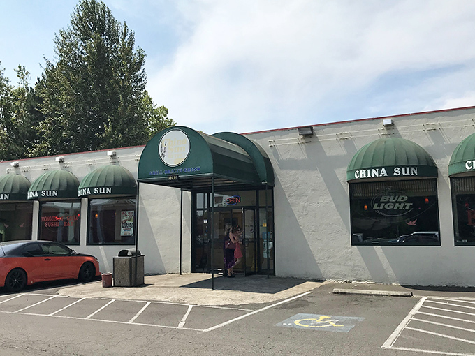 The distinctive green awnings of China Sun Buffet stand out against the white exterior, like beacons guiding hungry travelers to their destination.