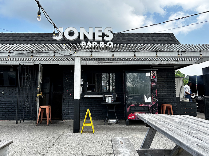 The unassuming black exterior of Jones Bar-B-Q speaks volumes: great barbecue doesn't need fancy digs, just smoke, skill, and soul.