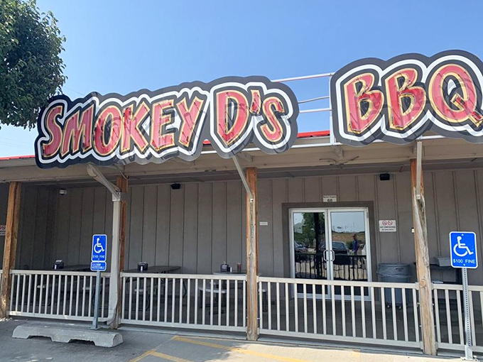 The neon-red sign of Smokey D's BBQ glows like a beacon for hungry souls, promising salvation through smoke and meat in Des Moines.