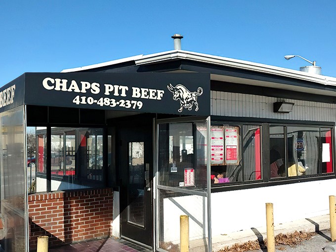 The unassuming exterior of Chaps Pit Beef &ndash; proof that culinary greatness often hides in plain sight, like a superhero's secret identity.