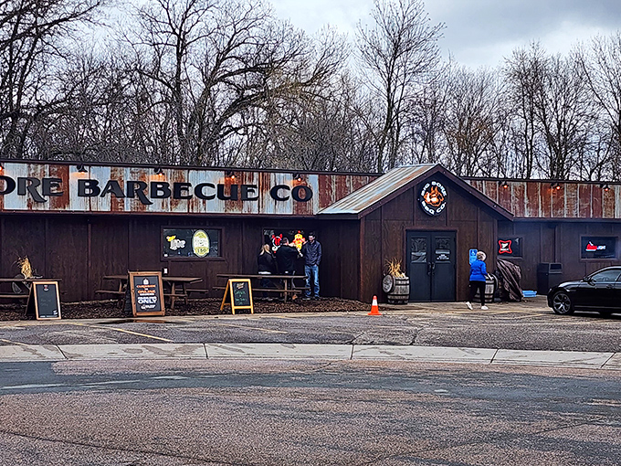 The weathered corrugated metal exterior of Big Bore Barbecue stands as a rustic beacon for meat lovers&mdash;industrial chic meets smokehouse authenticity.