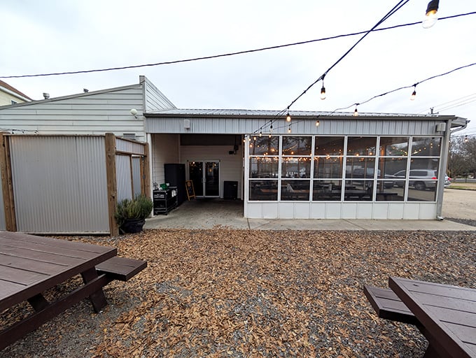 The iconic pig silhouette welcomes barbecue pilgrims to this Fondren district gem, where string lights promise good times ahead.