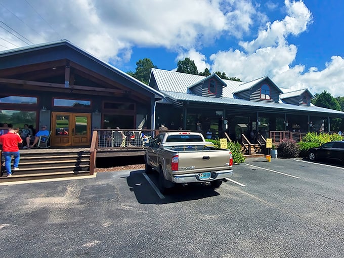 The log cabin exterior of The Sawmill Place stands proudly against blue Georgia skies, promising comfort food that'll make your soul do a happy dance.