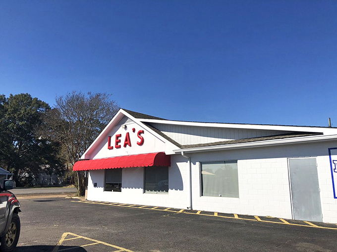 The iconic white building with bold red "LEA'S" lettering and matching awning stands as a beacon for hungry travelers &ndash; a Louisiana landmark since 1928.
