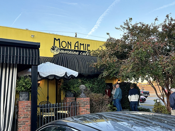 The sunshine-yellow exterior of Mon Amie isn't just a building&mdash;it's a morning promise waiting to be kept. French charm meets Southern hospitality behind those striped awnings.