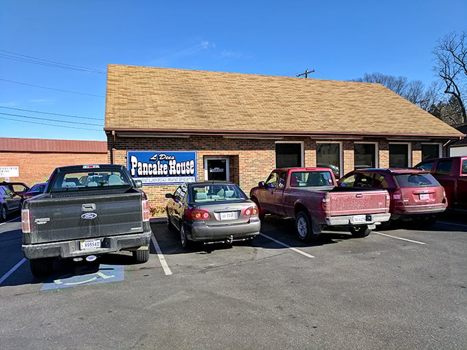 The unassuming brick exterior of L'Dees Pancake House, where pickup trucks in the parking lot signal you've found a true local treasure.
