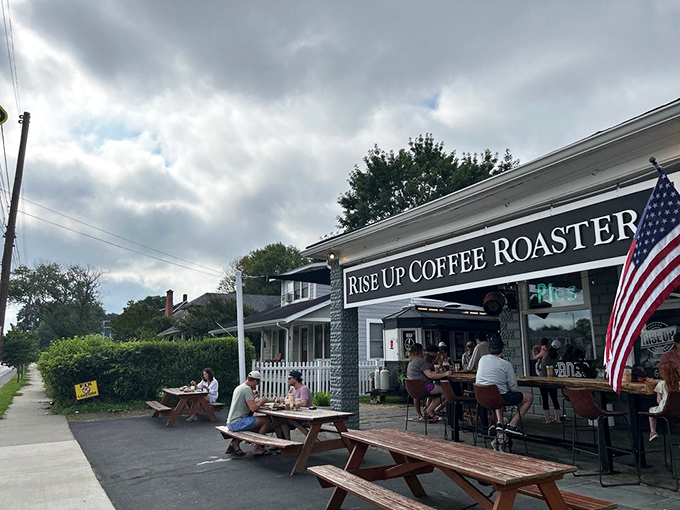 The Eastern Shore's coffee sanctuary beckons with rustic picnic tables and an American flag, promising caffeinated salvation for weary travelers.