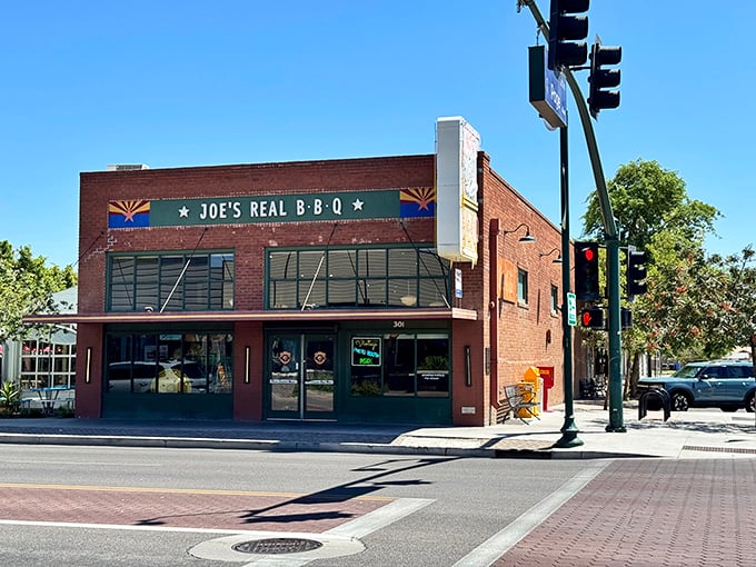 The brick facade of Joe's Real BBQ stands proudly on Gilbert's main drag, Arizona flags flanking its name like sentinels guarding a smoky treasure.