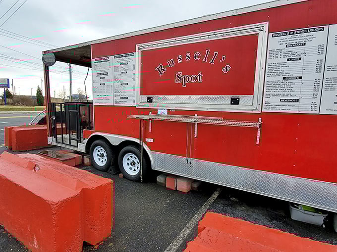 The bright red food trailer stands out like a culinary lighthouse, beckoning hungry travelers with its no-nonsense approach to serious barbecue.