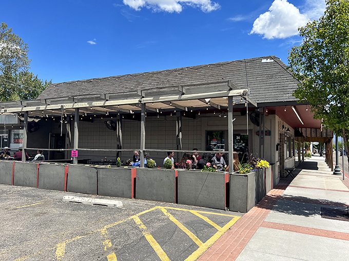 The unassuming exterior of Bodacious Pig Barbecue in Eagle hides culinary treasures within. That patio practically begs you to settle in for a smoky feast.