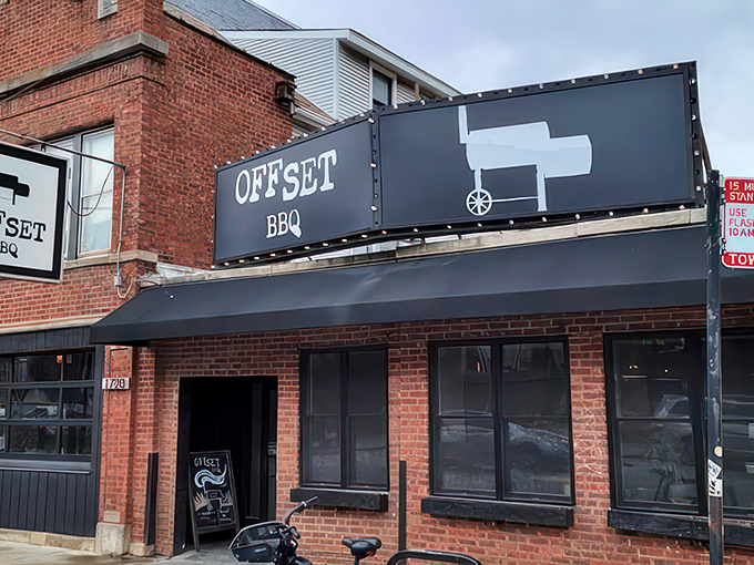 The glowing Offset BBQ sign beckons like a lighthouse for the hungry&mdash;Chicago's barbecue beacon against the twilight sky.