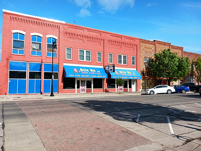 The bright blue awning of Bite Me BBQ stands out like a beacon of smoky hope on Wichita's St. Francis Street, promising delicious rebellion in every bite.