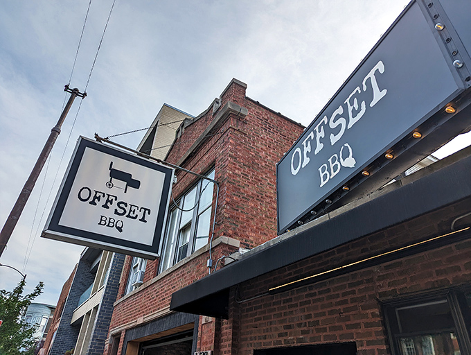 The glowing Offset BBQ sign beckons like a lighthouse for the hungry&mdash;Chicago's barbecue beacon against the twilight sky. 