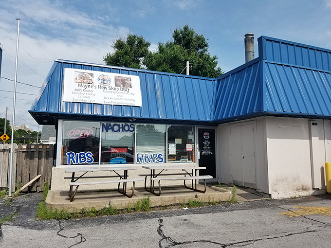 The blue exterior of Wayne's New Skoo BBQ beckons like a smoke signal to hungry travelers. This unassuming strip mall spot proves Nebraska's barbecue scene is no flyover affair.