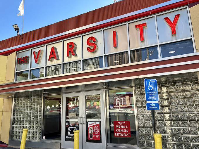 The iconic yellow and red exterior of The Varsity stands like a time capsule of American dining, beckoning hungry travelers with its retro charm.