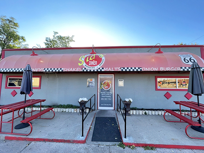 Route 66 nostalgia meets burger paradise at Sid's Diner, where the coral exterior and checkered trim promise a taste of authentic Americana.