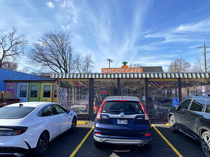 The unassuming exterior of The Root Cafe, where culinary magic hides behind a modest facade topped with that iconic carrot sign.