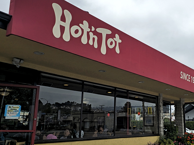 The iconic red awning of Hot N Tot beckons like a lighthouse for hungry souls navigating the Pacific Coast Highway. Classic California diner perfection.