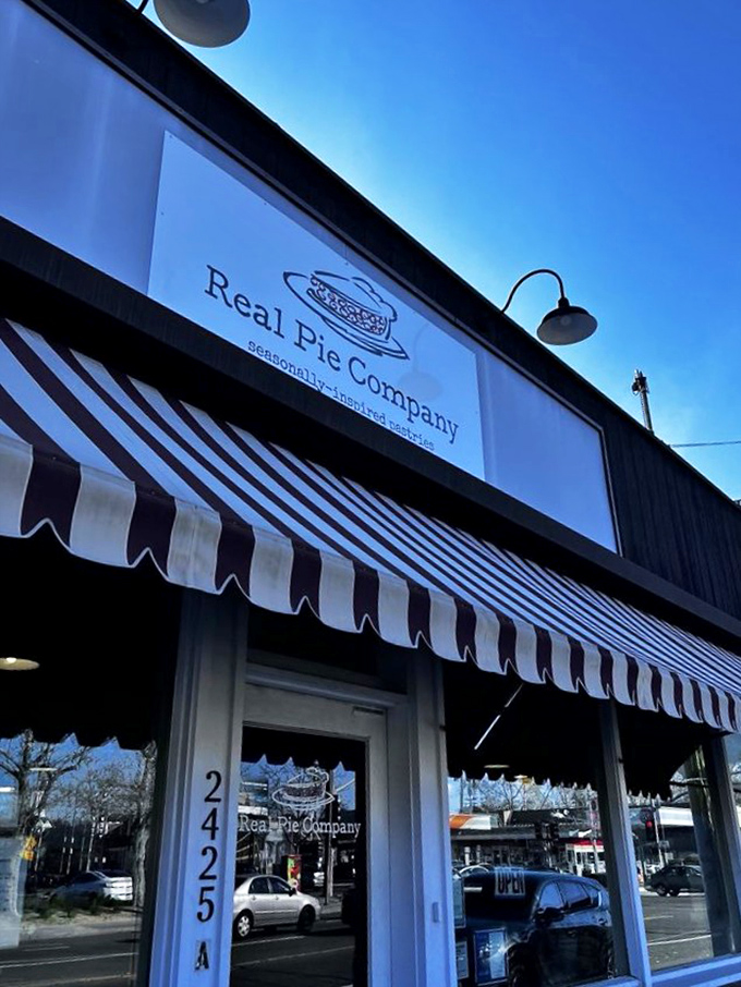 The red-and-white striped awning isn't just charming - it's nature's way of signaling "life-changing pie ahead," like a delicious warning system for your taste buds.