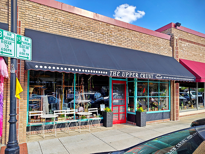 The unassuming storefront of The Upper Crust beckons like a siren song to pie lovers. That navy awning and bright red door are basically saying, "Get in here, hungry person!"