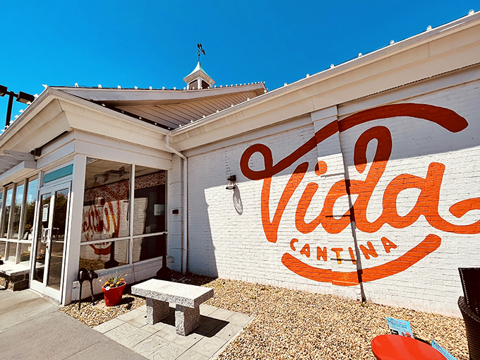 The unassuming exterior hides a culinary fiesta within&mdash;like finding a perfect beach behind an ordinary door, Vida Cantina's vibrant orange script promises adventure.