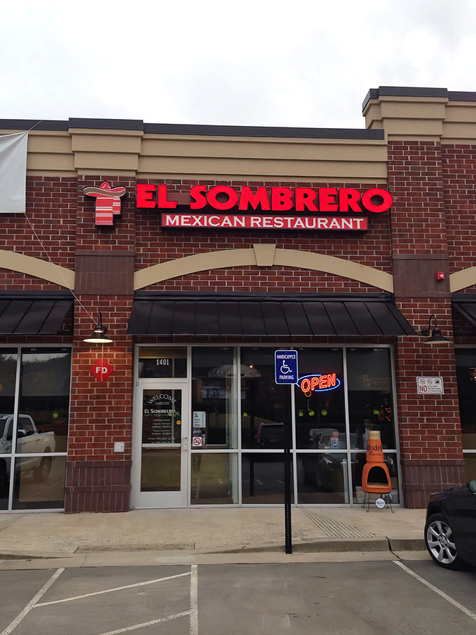 The unassuming brick exterior of El Sombrero belies the culinary treasures within. Red signage and a simple "OPEN" sign invite curious diners to discover Franklin's hidden Mexican gem.