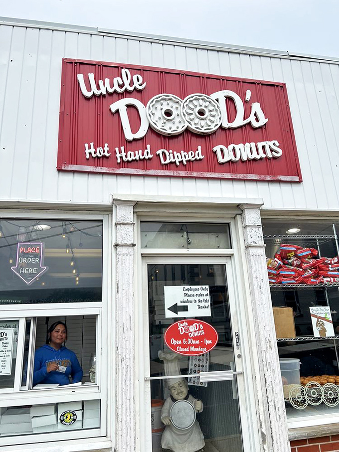 The iconic red and white sign promises "Hot. Hand. Dipped. Donuts." &mdash; four words that might be the sweetest poetry ever written on a storefront.