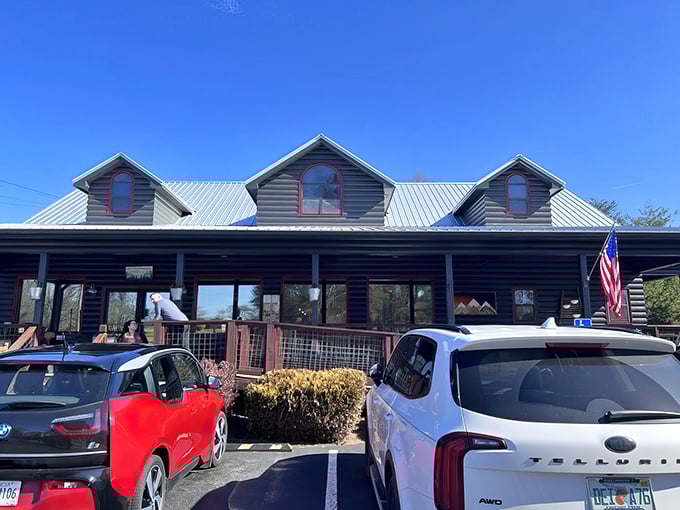 The log cabin exterior of The Sawmill Place stands proudly against blue Georgia skies, promising comfort food that'll make your soul do a happy dance.