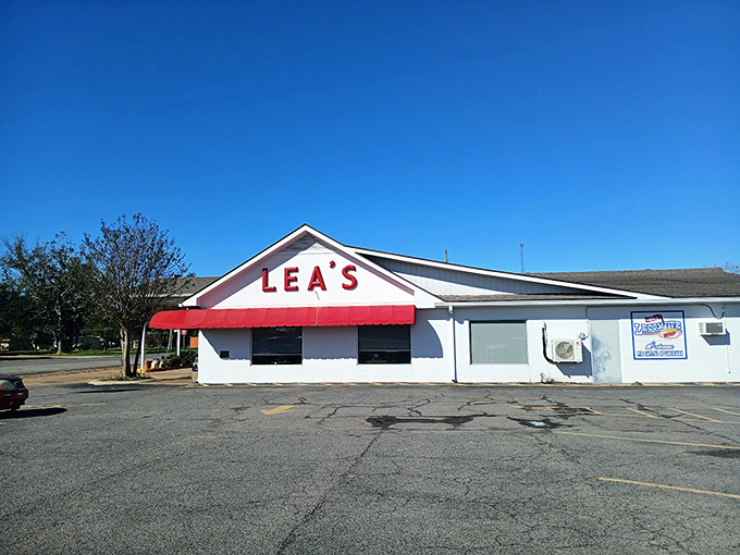 The iconic white building with bold red "LEA'S" lettering and matching awning stands as a beacon for hungry travelers &ndash; a Louisiana landmark since 1928.