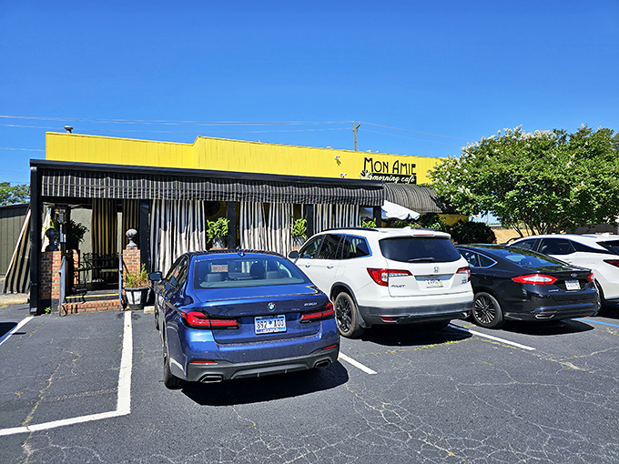 The sunshine-yellow exterior of Mon Amie isn't just a building&mdash;it's a morning promise waiting to be kept. French charm meets Southern hospitality behind those striped awnings.