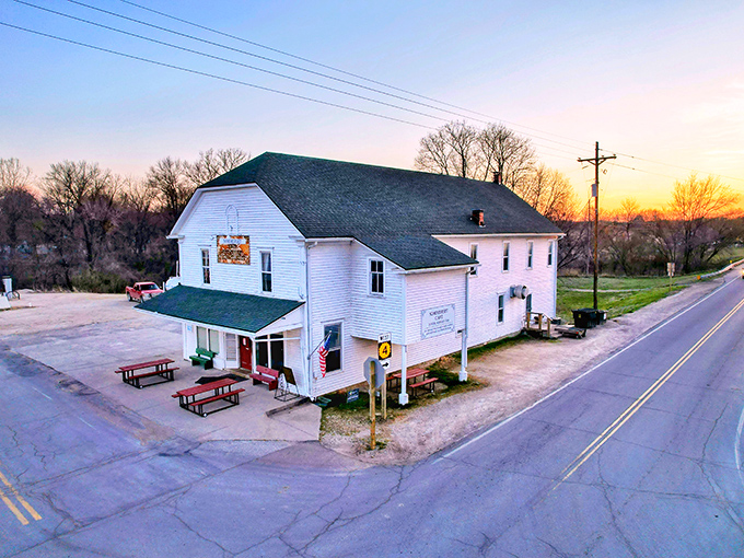 The white clapboard building stands like a time capsule at a rural crossroads, promising comfort food treasures within its unassuming walls.