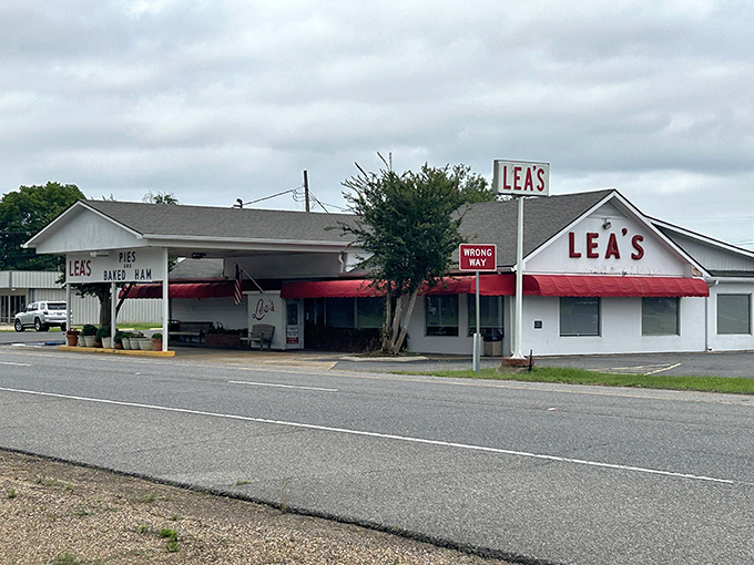 Lea's iconic white exterior with its cherry-red awning stands as a beacon of hope for hungry travelers. Simple, unassuming, and promising delicious rewards inside. 