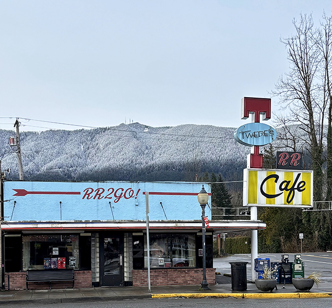 The iconic blue and yellow Twede's Cafe sign stands tall against the Washington sky, beckoning hungry travelers with promises of pie-fueled happiness. 