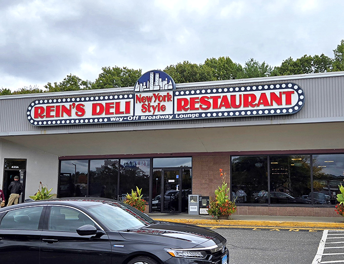 The iconic Rein's Deli sign glows like a Broadway marquee in Connecticut, promising New York flavors without the traffic or attitude.