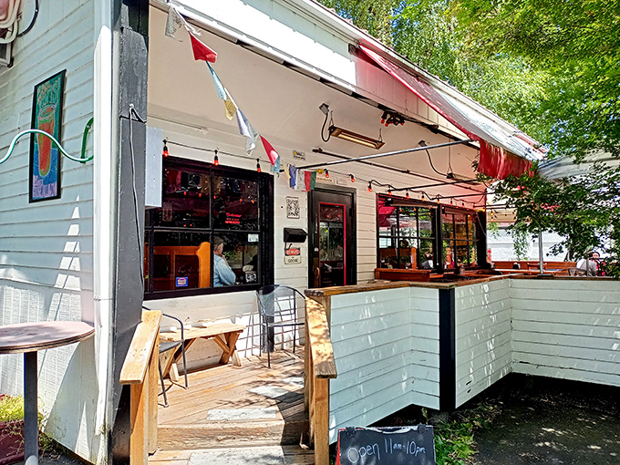 The charming white exterior of Goose Hollow Inn, where weeping willows create nature's perfect canopy for Portland's beloved sandwich sanctuary.