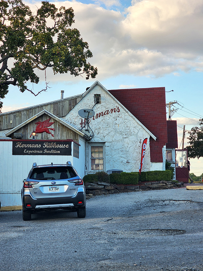The humble white exterior with its iconic red roof and flying pig logo promises a carnivorous adventure that Arkansas locals have treasured since 1964.