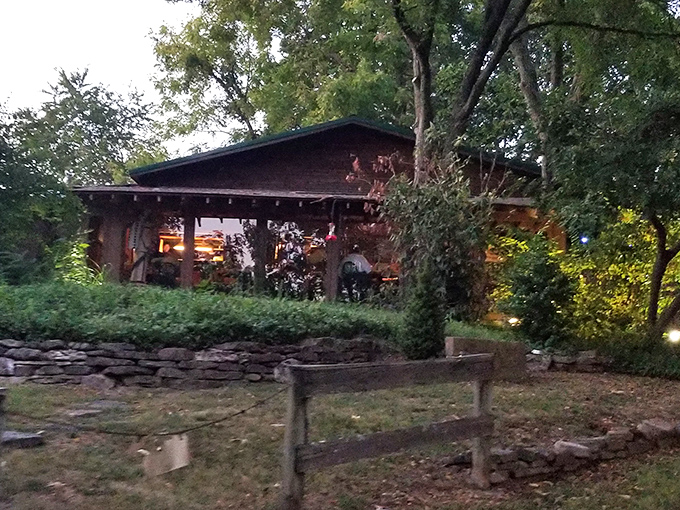 The rustic cabin exterior of The Steak Inn emerges from the Ozark forest like a carnivore's mirage, promising chargrilled treasures within.
