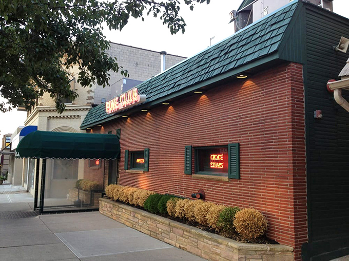 The iconic red neon sign beckons hungry diners like a lighthouse guiding ships to safe harbor. Pure steakhouse magic awaits.