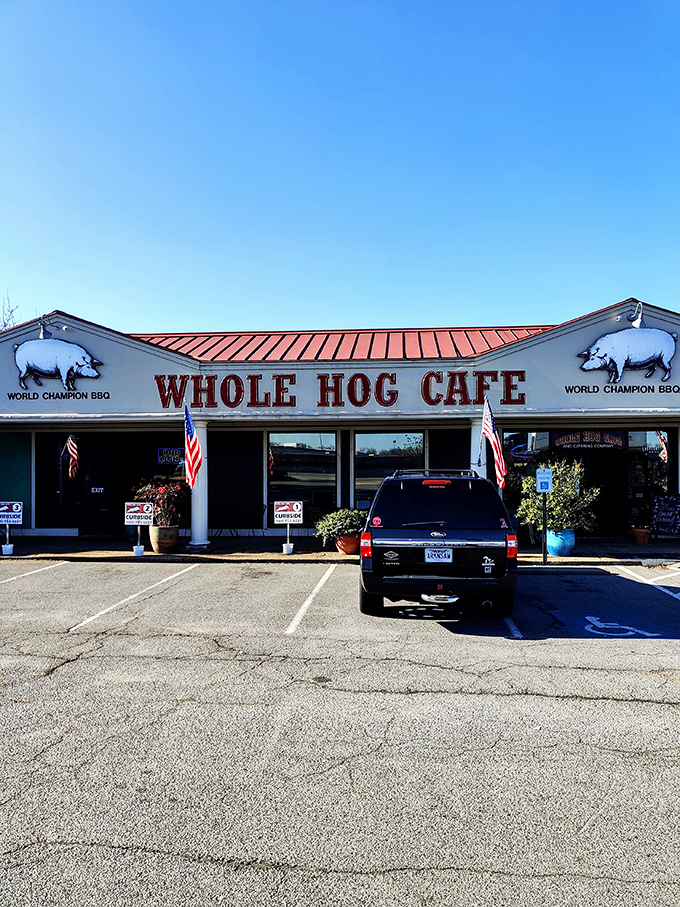 The barbecue beacon of North Little Rock stands proud with its red roof and pig silhouettes, boldly declaring its championship status to hungry passersby.