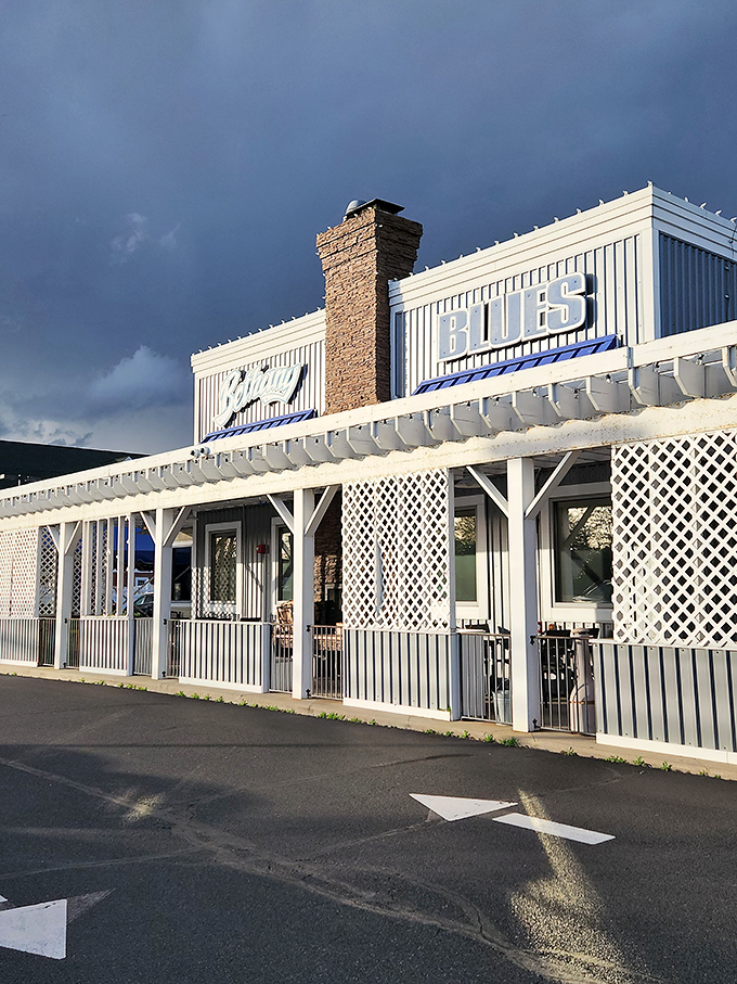Bethany Blues' inviting exterior promises barbecue salvation with its distinctive blue roof and welcoming stone entrance&mdash;a coastal Delaware landmark that beckons hungry travelers.