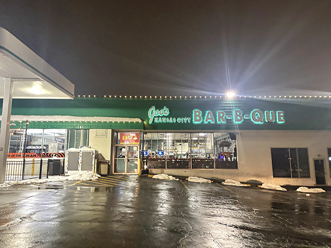 The green facade of barbecue paradise beckons like a smoky mirage. Who knew a gas station could house such legendary meaty treasures?