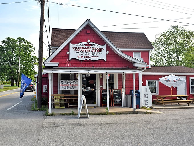 The cherry-red clapboard exterior of Tilghman Island Country Store stands like a beacon of hope for hungry travelers, promising culinary treasures within its humble walls.