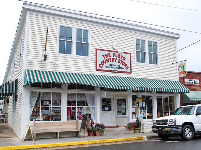 The classic white clapboard exterior of Floyd Country Store stands as a beacon of Appalachian charm, complete with that iconic green-striped awning that practically whispers, "Come on in, y'all."