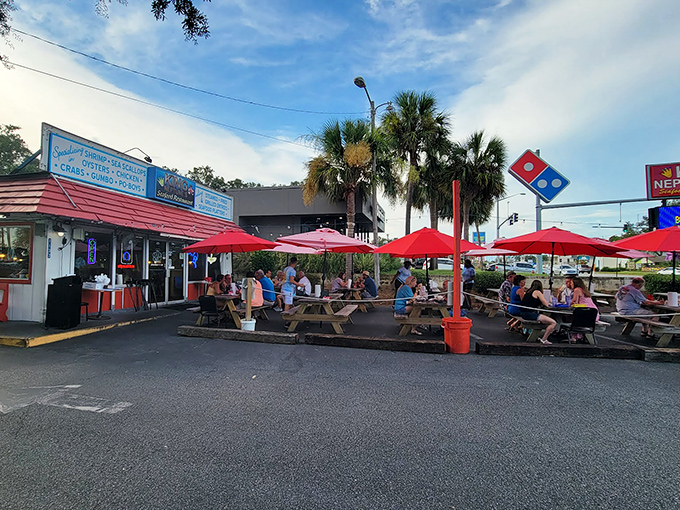 The unassuming exterior of King Neptune's hides culinary treasures within. Those red umbrellas aren't just for show&mdash;they're beacons for seafood lovers.