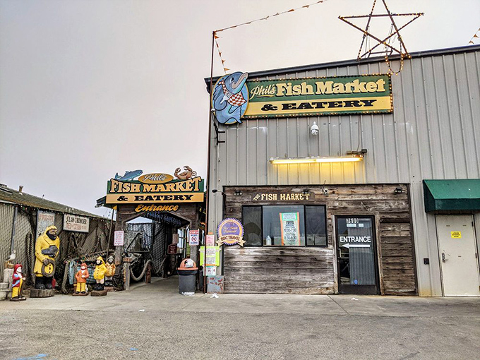 The unassuming exterior of Phil's Fish Market stands beneath Castroville's iconic sign, proving that culinary treasures often hide in plain sight.